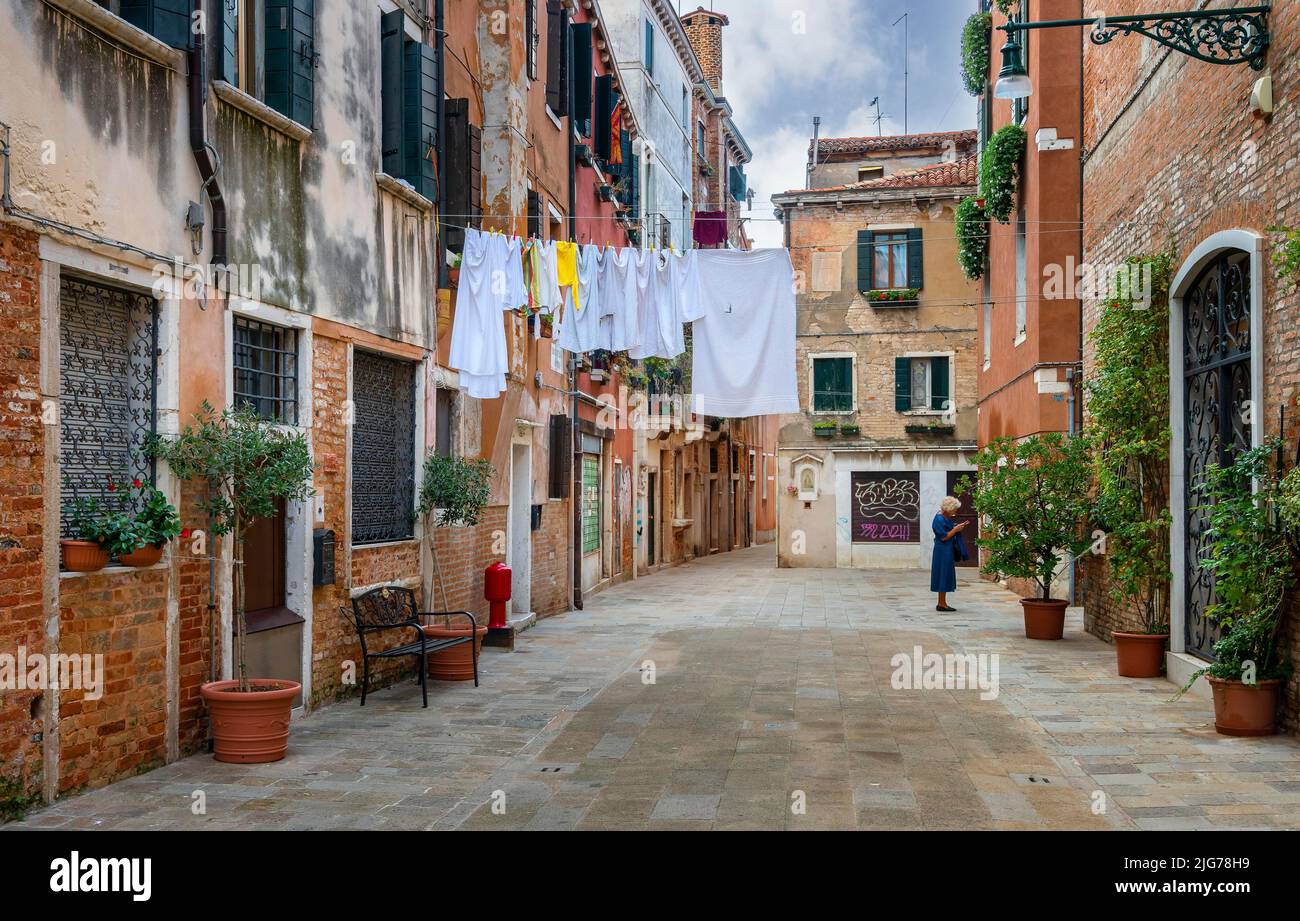 Laundry on a line in front of the typical Venetian house facades in the ...