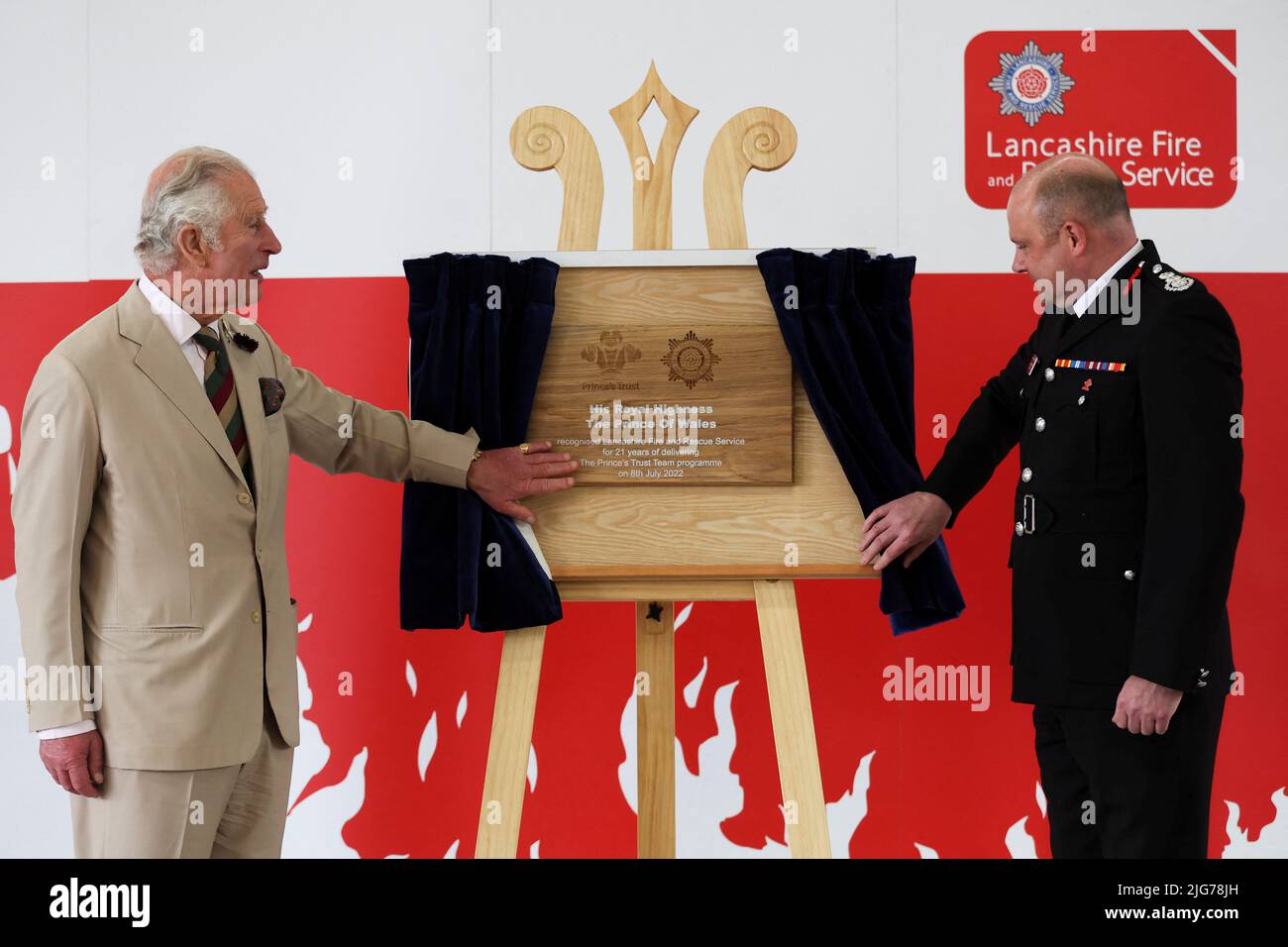 The Prince of Wales unveils a plaque during a visit to Morecambe Fire ...