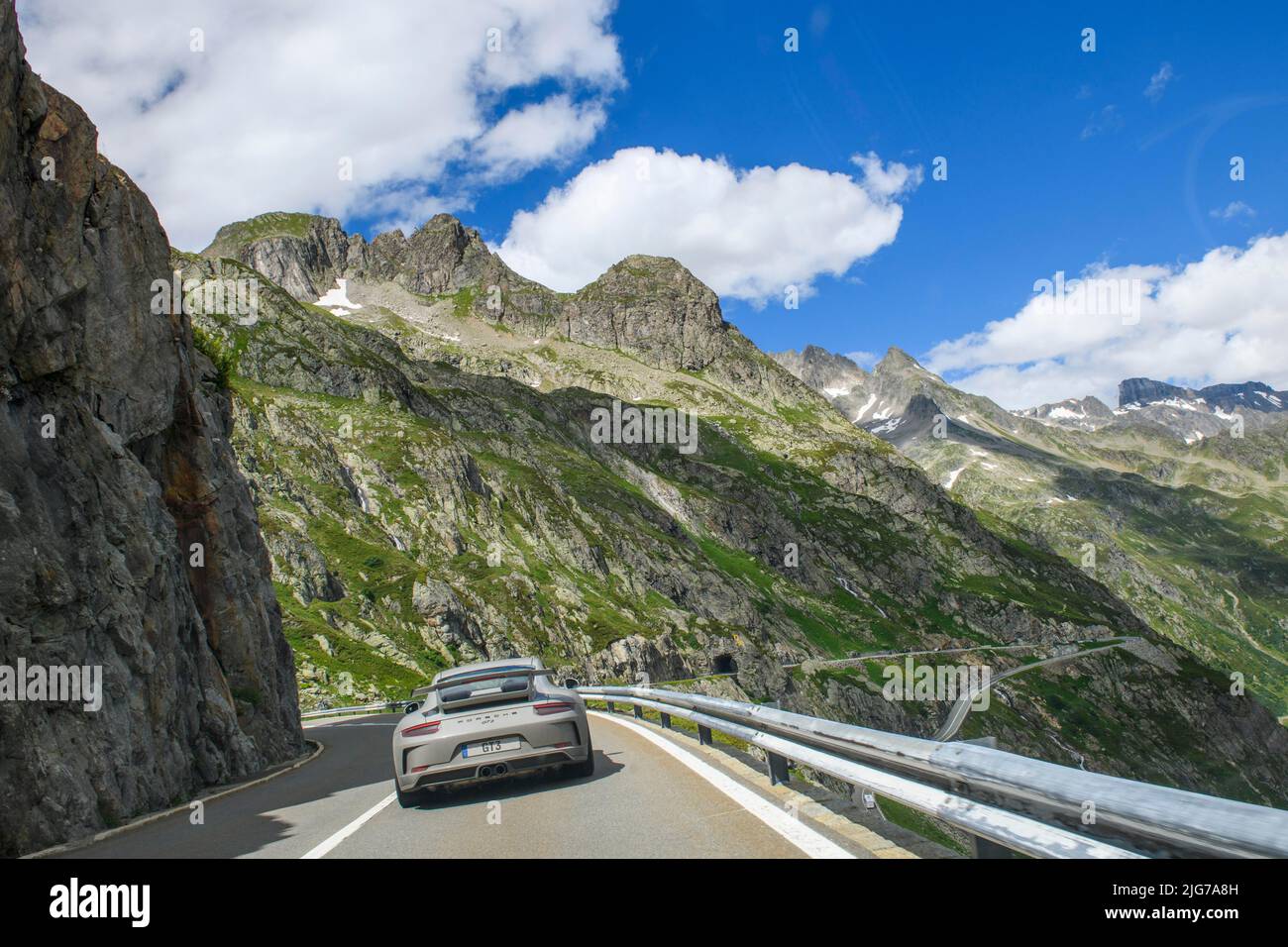 Porsche 911 GT3 sports car on a mountain road on the Susten Pass above ...
