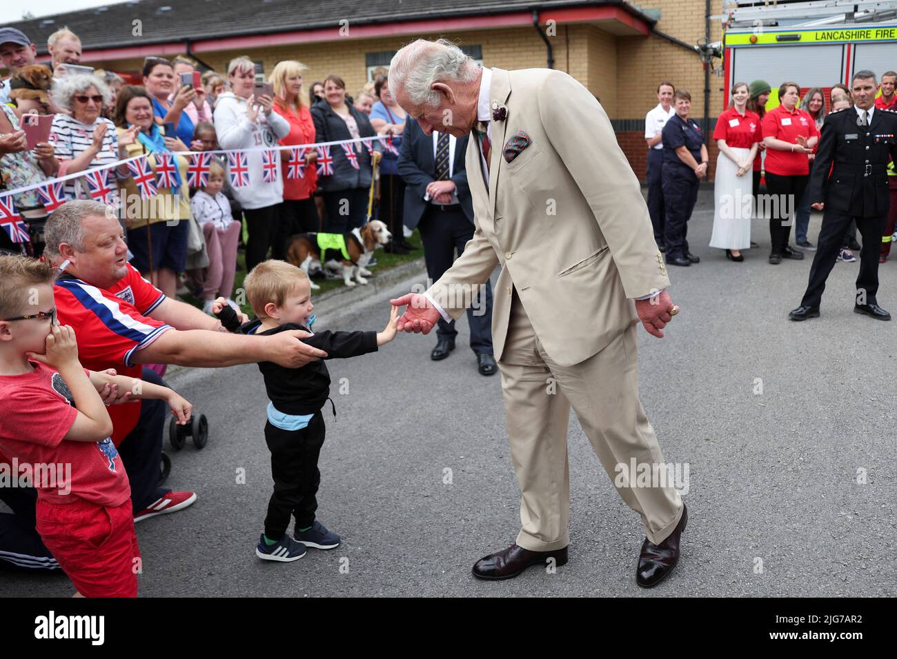 The Prince of Wales greets a child during a visit to Morecambe Fire ...
