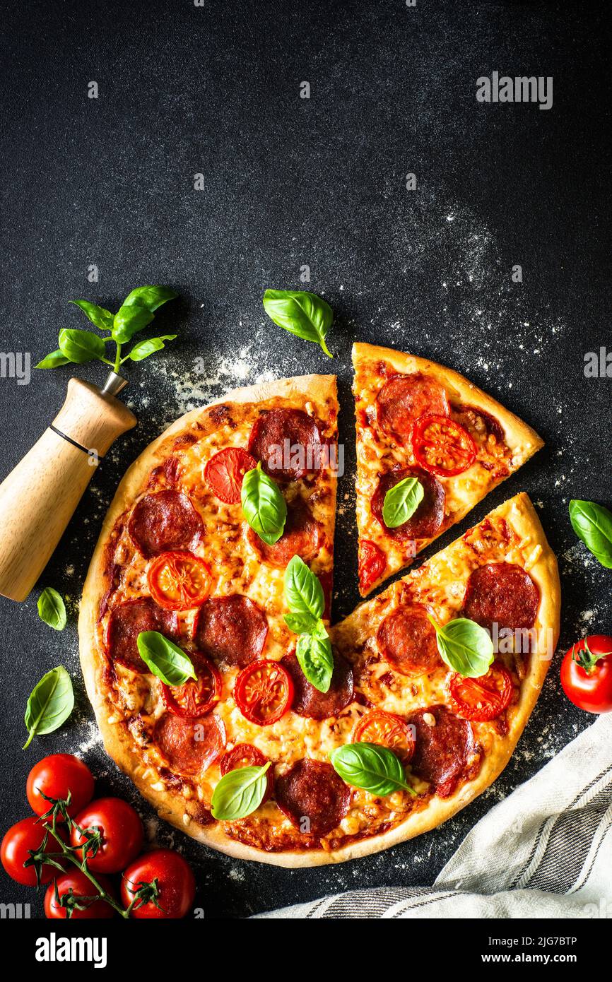 Traditional italian pizza with salami cheese, tomatoes and basil Stock ...