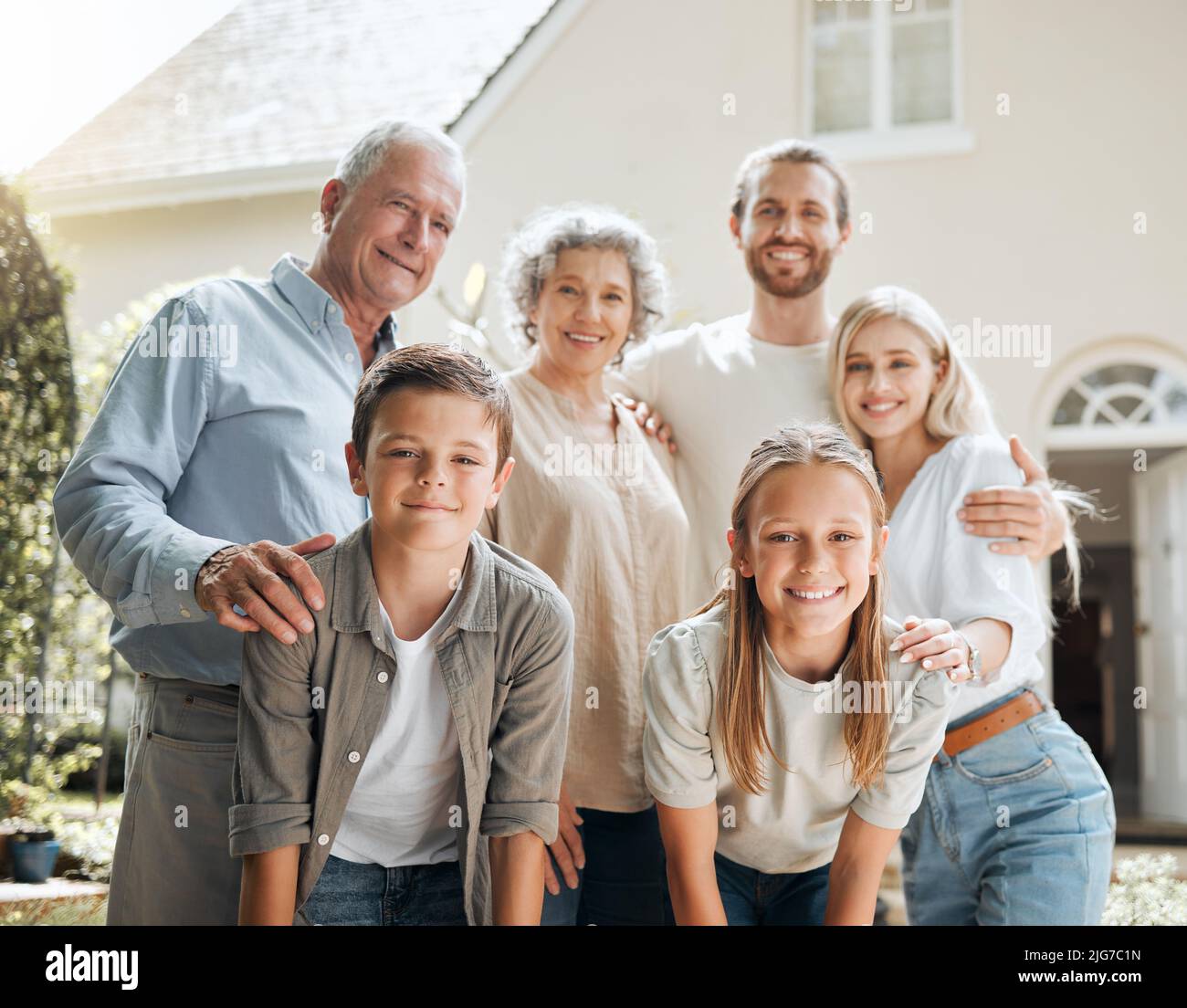 Keep your family close. Shot of a multi-generational family standing ...