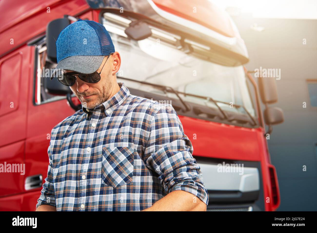 Professional Caucasian Semi Truck Driver in His 40s in Front of His Red ...