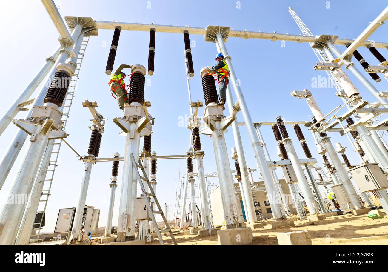 ZHANGYE, CHINA - JULY 7, 2022 - Construction workers install substation equipment at the ...