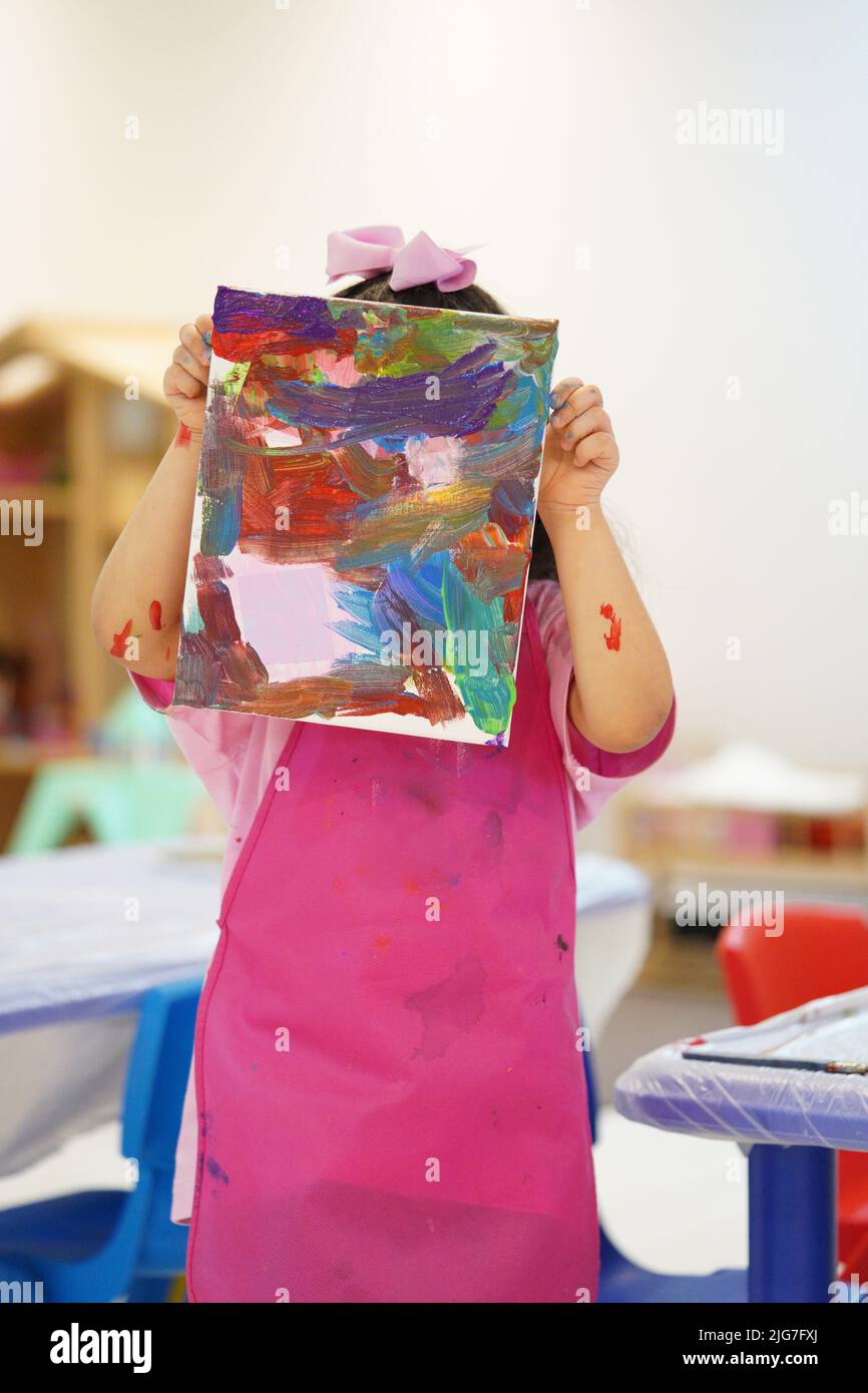 A little child girl holding peace of art, Kids painting messy painting ...