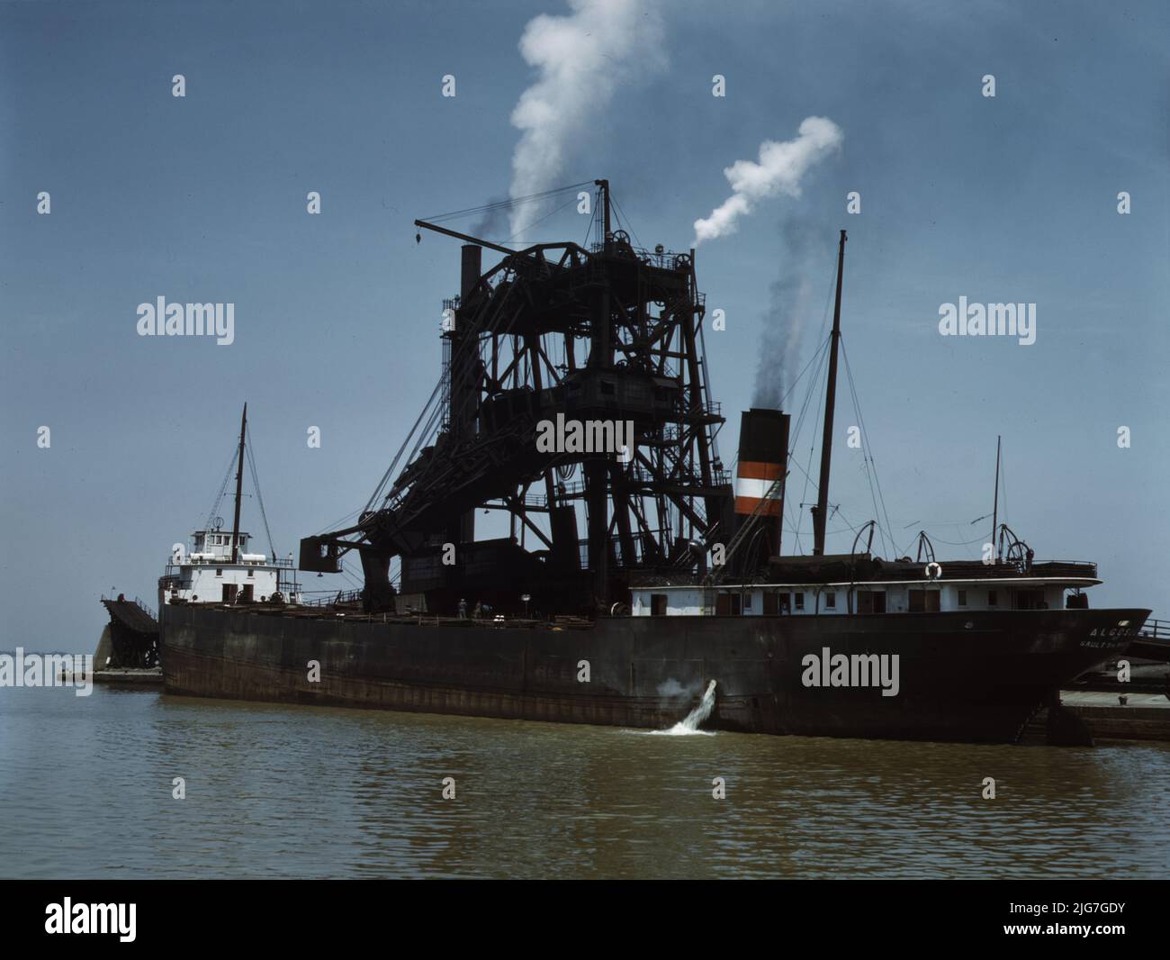 Loading coal into a freighter at one of the Pennsylvania Railroad docks ...