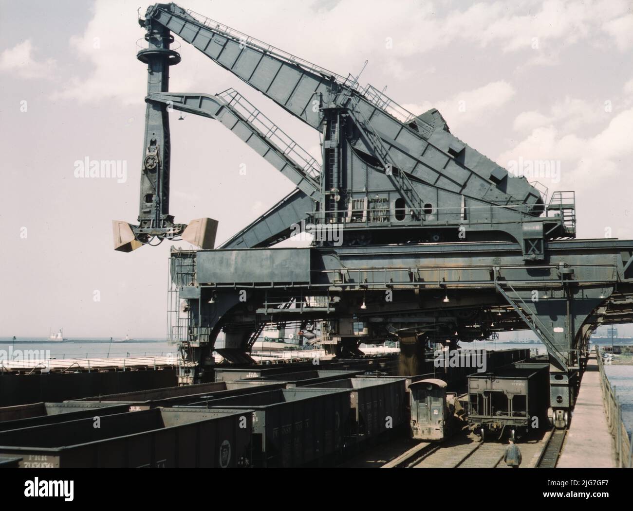 Unloading a lake freighter at the Pennsylvania Railroad iron ore docks ...