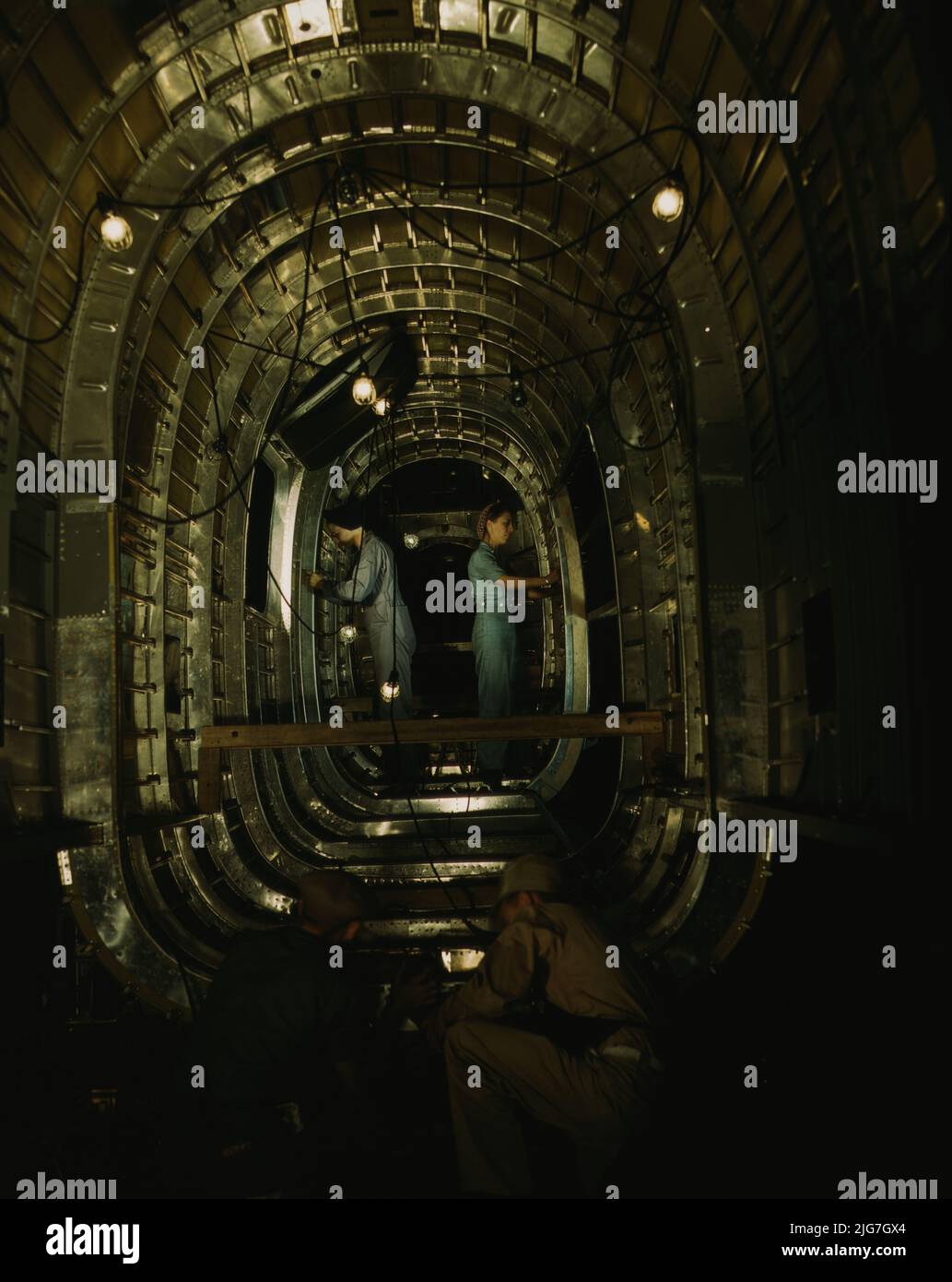 Installing structural parts of a C-87 transport plane in the tunnel of ...