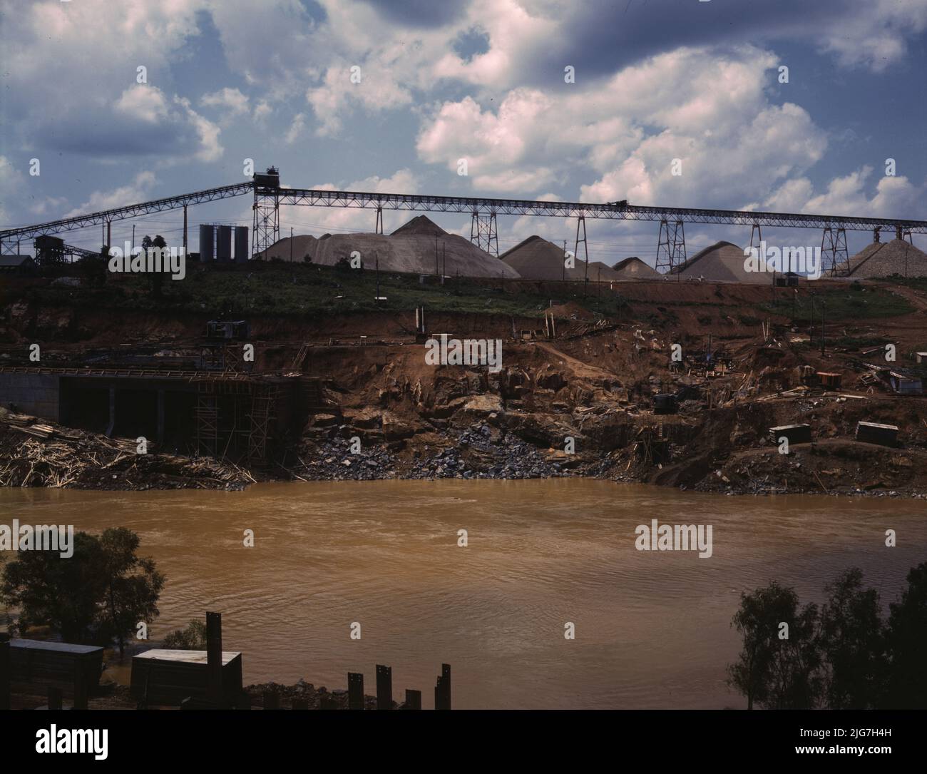 Above the construction work, the aggregate storage pile which provides ...