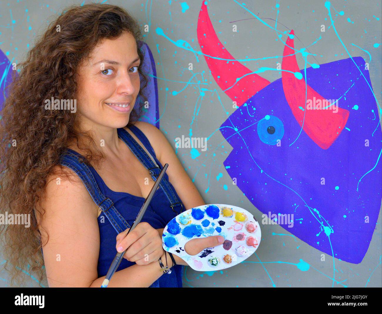 Smiling beautiful young female Mexican painter (visual artist) with ...