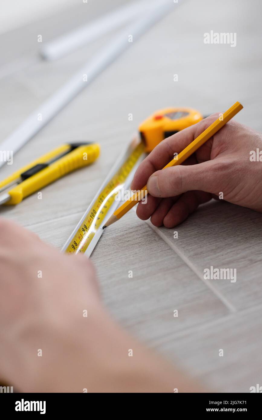 Man hands measuring decorative plastic corner. Repairing at home Stock ...