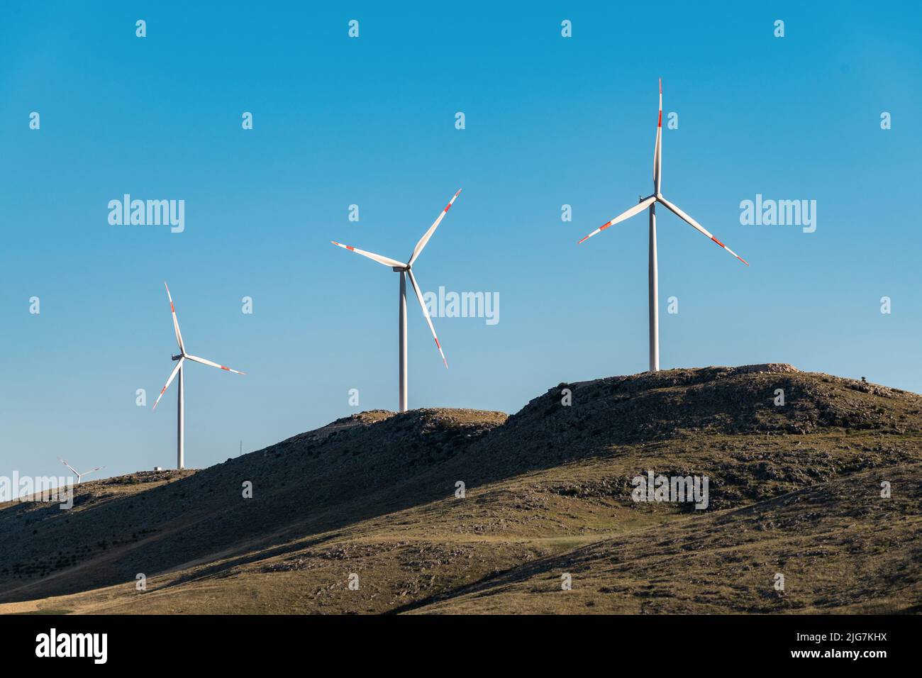 clean electricity producing wind turbine or windmill built on a windy ...