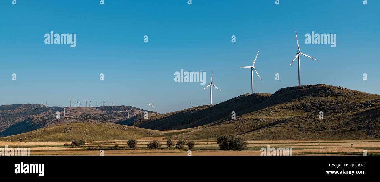 clean electricity producing wind turbine or windmill built on a windy ...