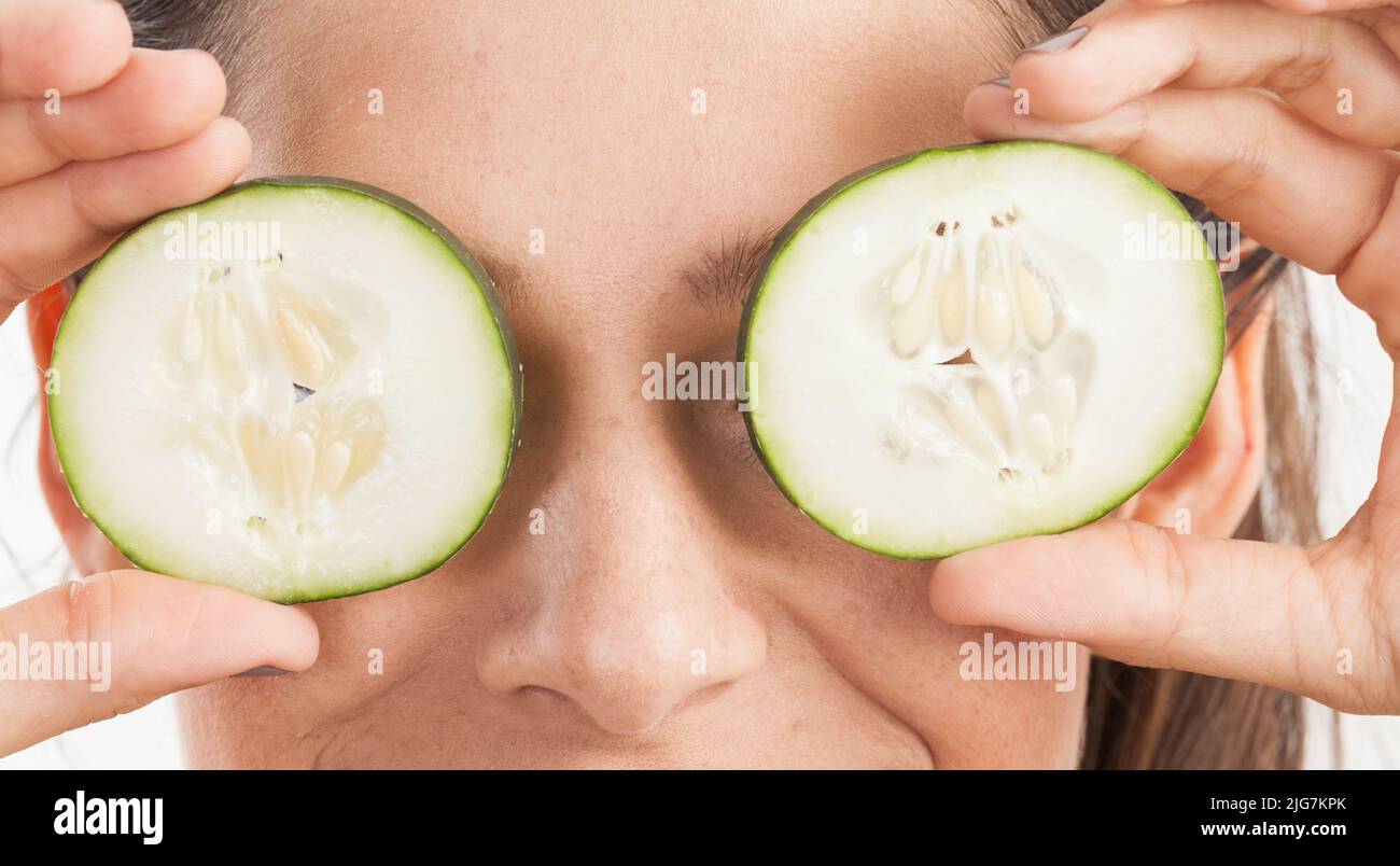 Beauty treatment, woman with cucumber slice in eyes Stock Photo - Alamy
