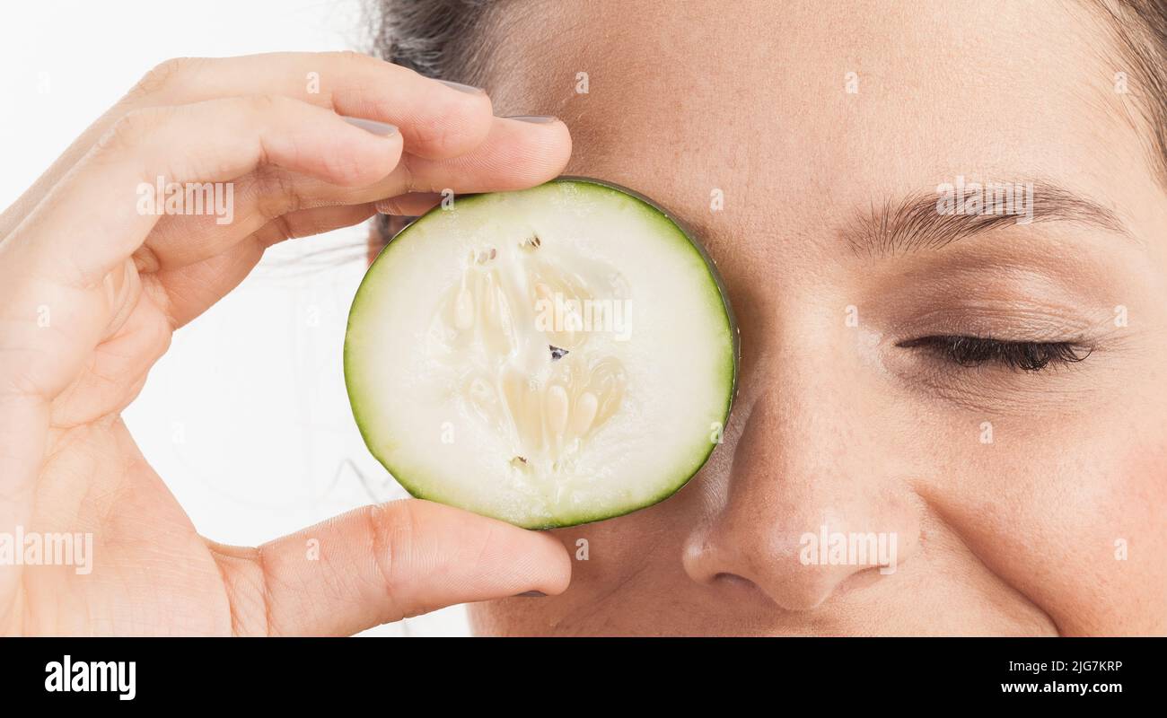 Beauty treatment, woman with cucumber slice in eyes Stock Photo - Alamy