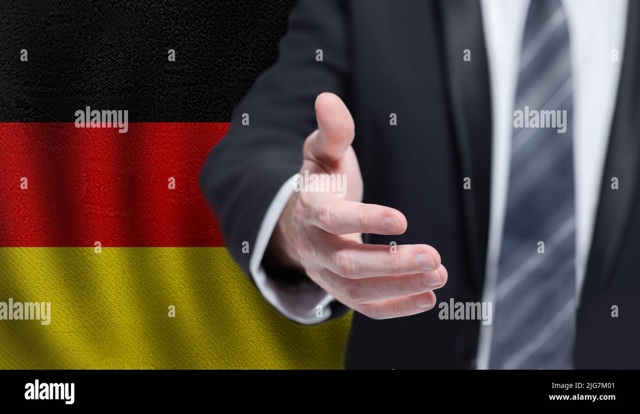 German business, politics, cooperation and travel concept. Hand on flag ...