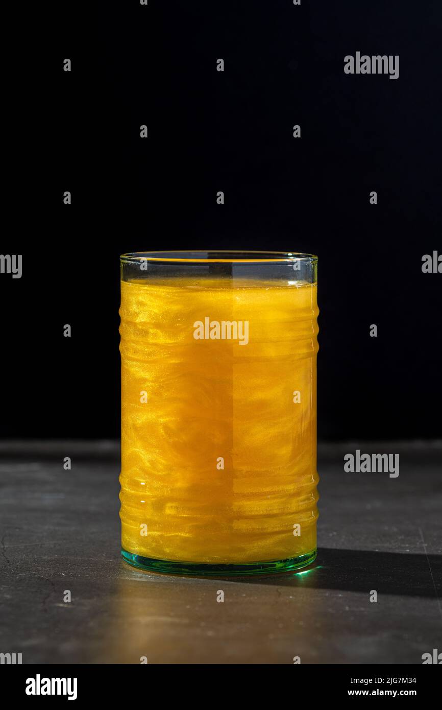 Cold icy drink with golden edible glitter or shimmer powder Stock Photo ...