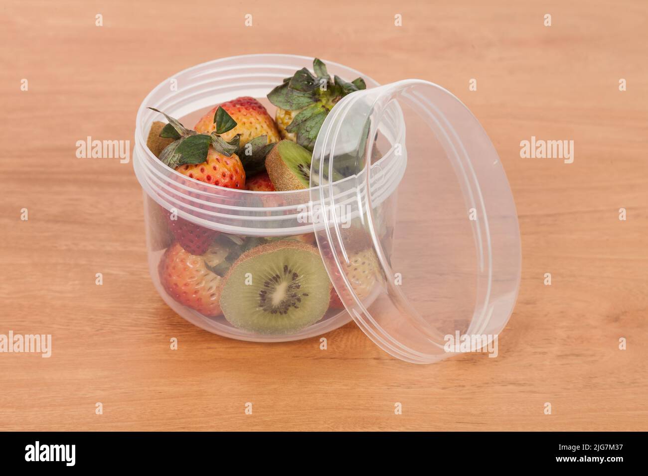 Transparent container with chopped fruit Stock Photo - Alamy