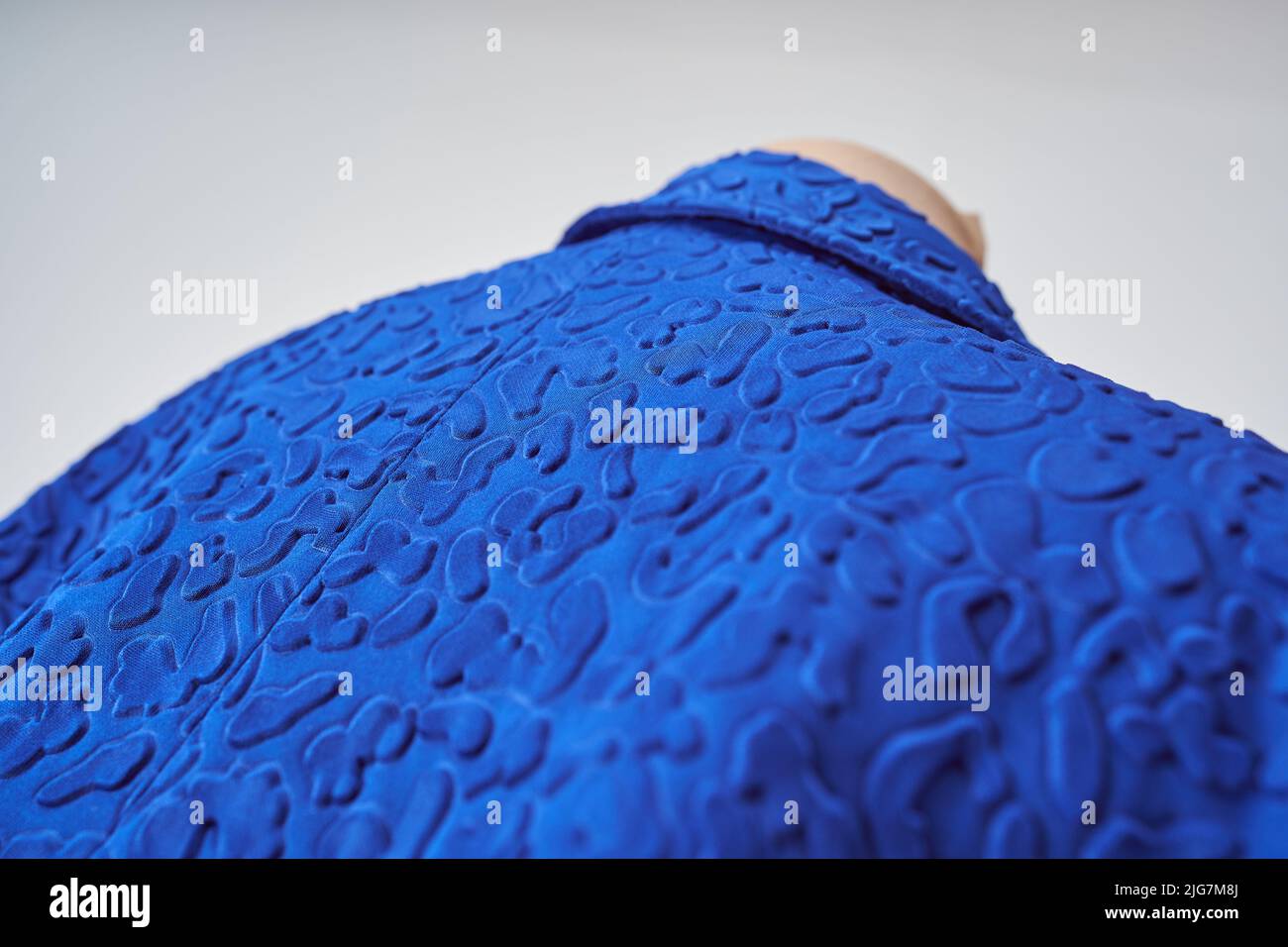 back collar and back of blue jacket in fabric with design Stock Photo ...