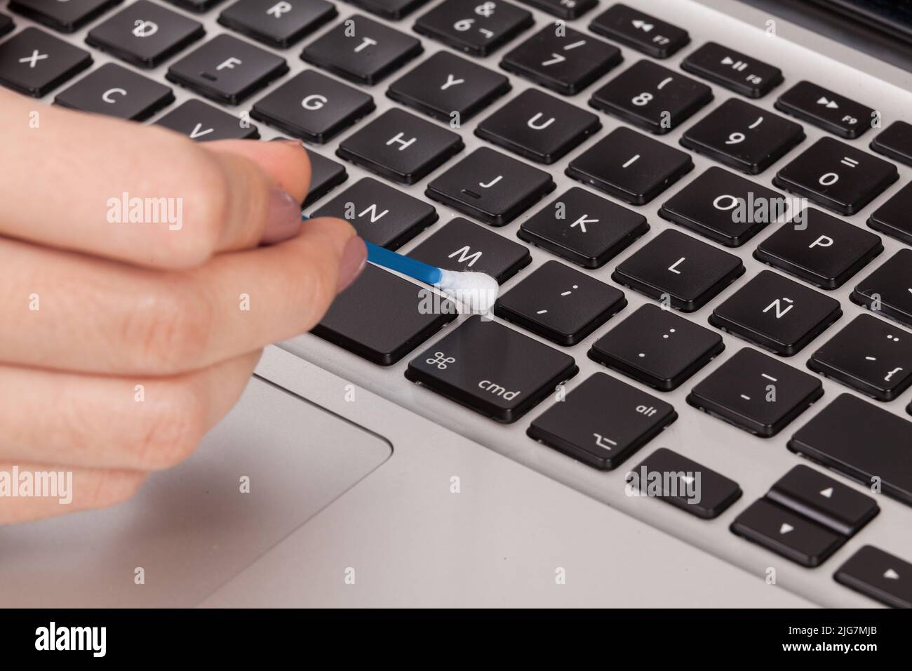 Female hand wiping laptop computer keys with a swab Stock Photo - Alamy