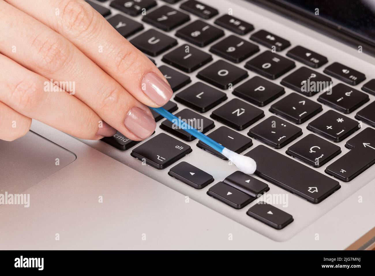 Female hand wiping laptop computer keys with a swab Stock Photo - Alamy