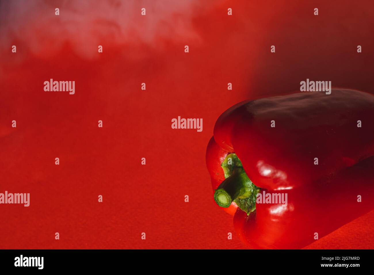 SWEET, fresh RED PEPPER ON A RED BACKGROUND WITH A LIGHT SMOKE Stock ...