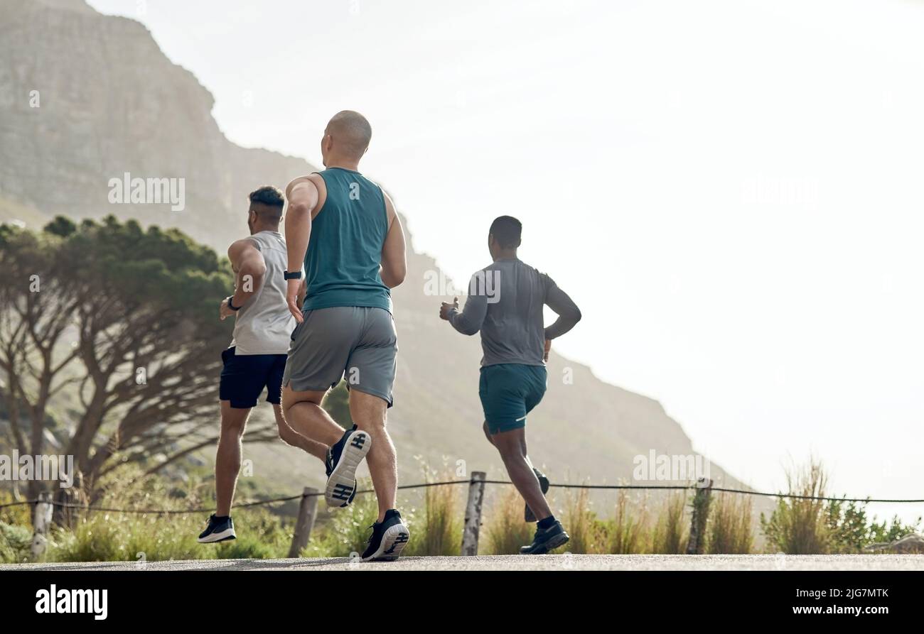 This is how we spend boys time. Shot of three men out for a run on a ...