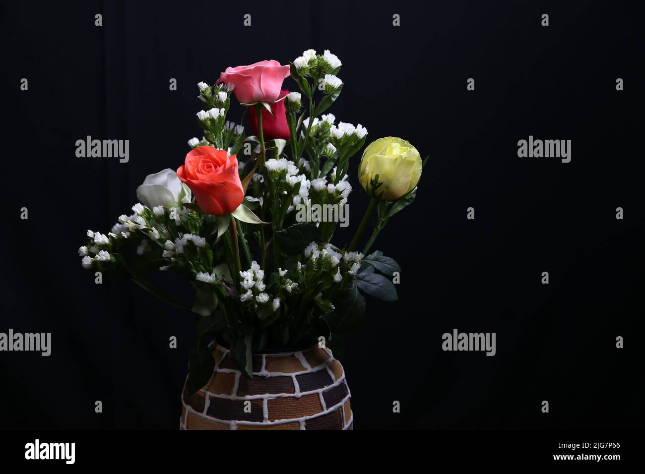 Vase with beautiful red rose flowers on black background Stock Photo ...