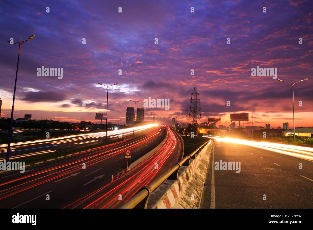 Heavy night time traffic moving through the roundabout and concrete ...