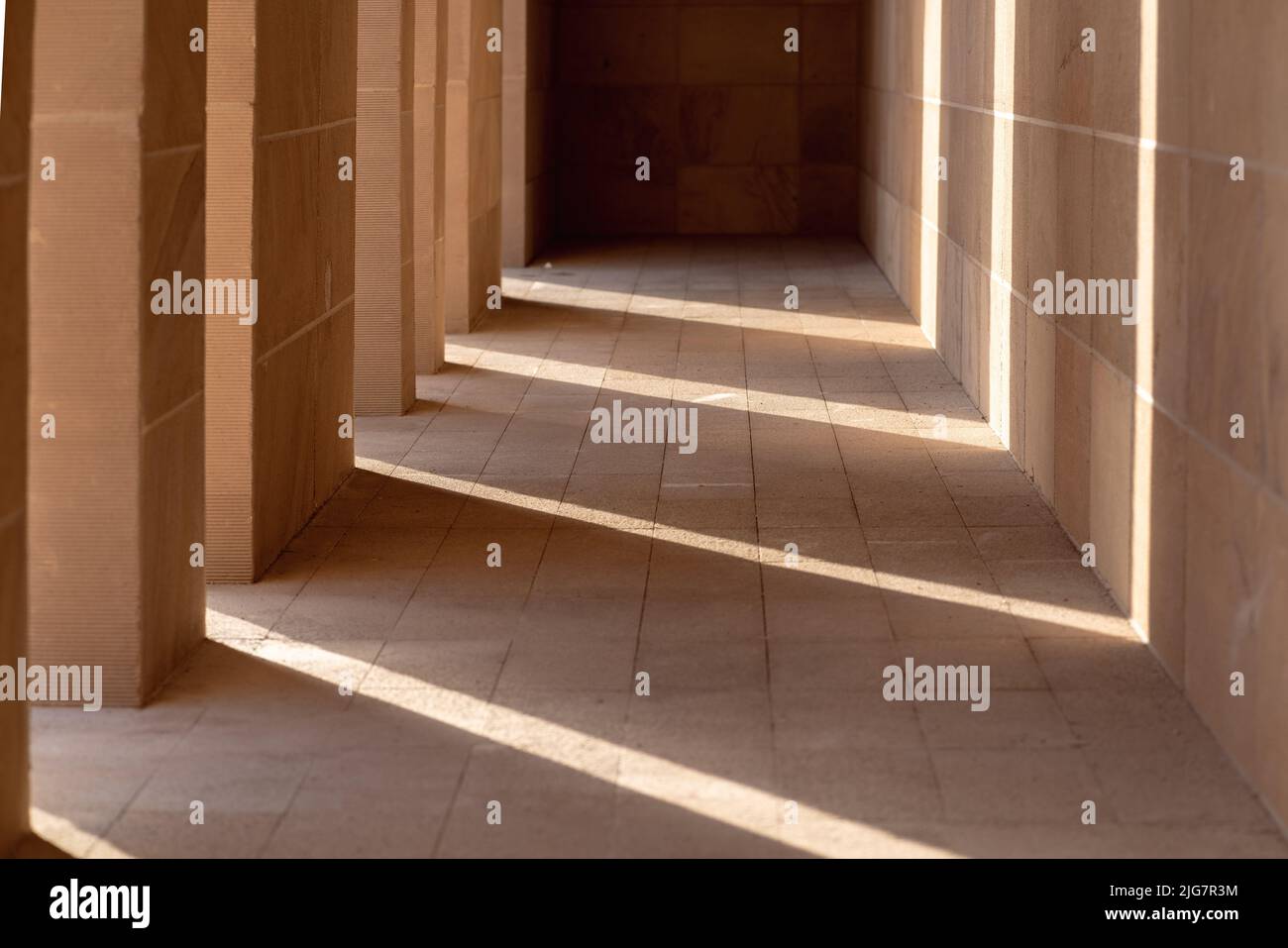 A beautiful outdoors hallway of a building with columns in sunny ...