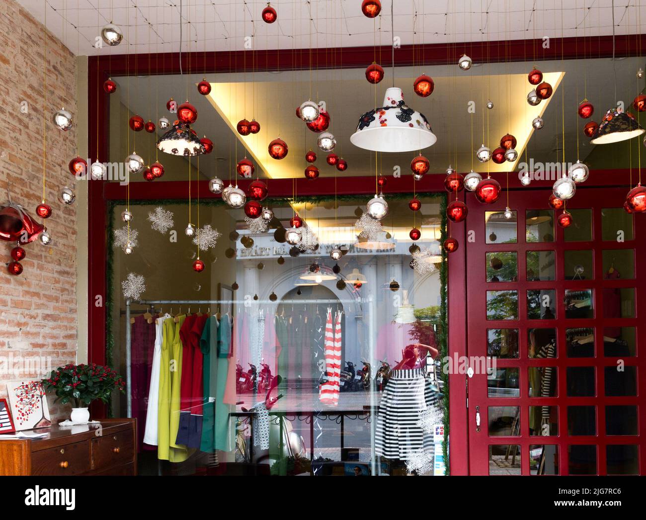 A Christmas tree with brightly colored glass balls inside a white ...