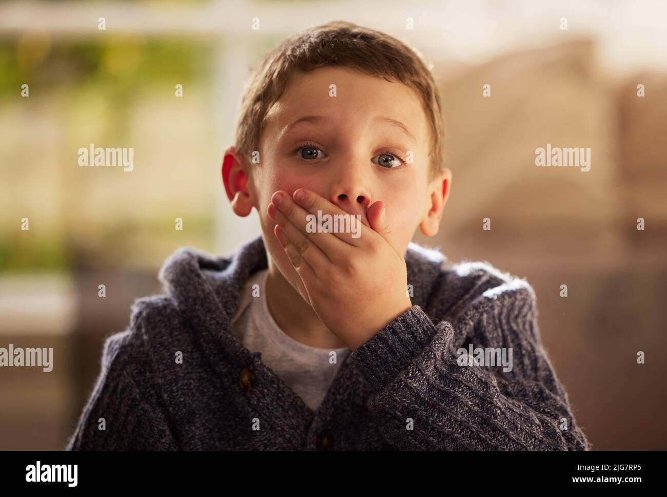 Dad said not to spill. Portrait of a cute little boy reacting to ...