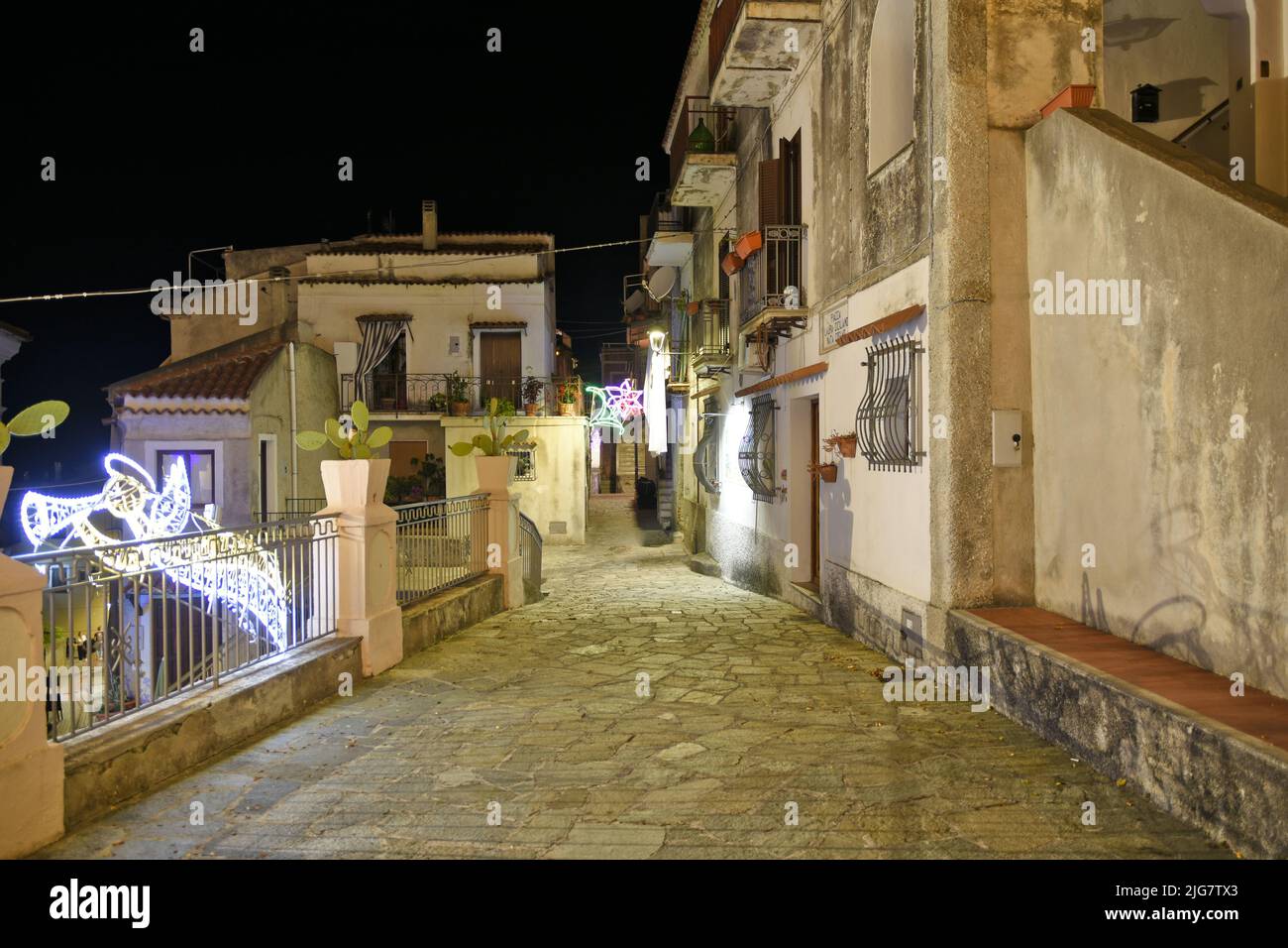 A narrow street with old buildings in San Nicola Arcella, village of ...