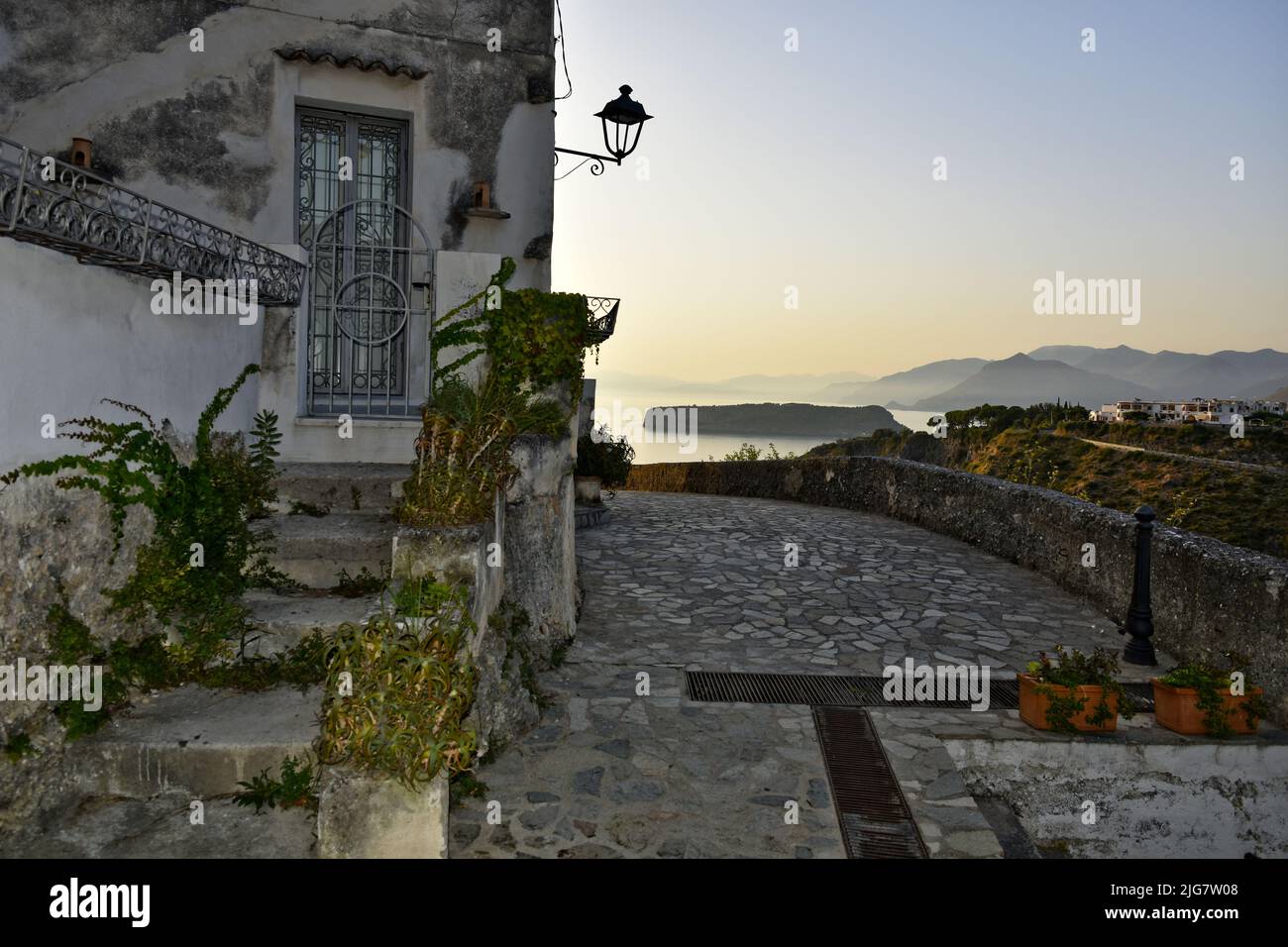 A narrow street with old buildings in San Nicola Arcella, village of ...