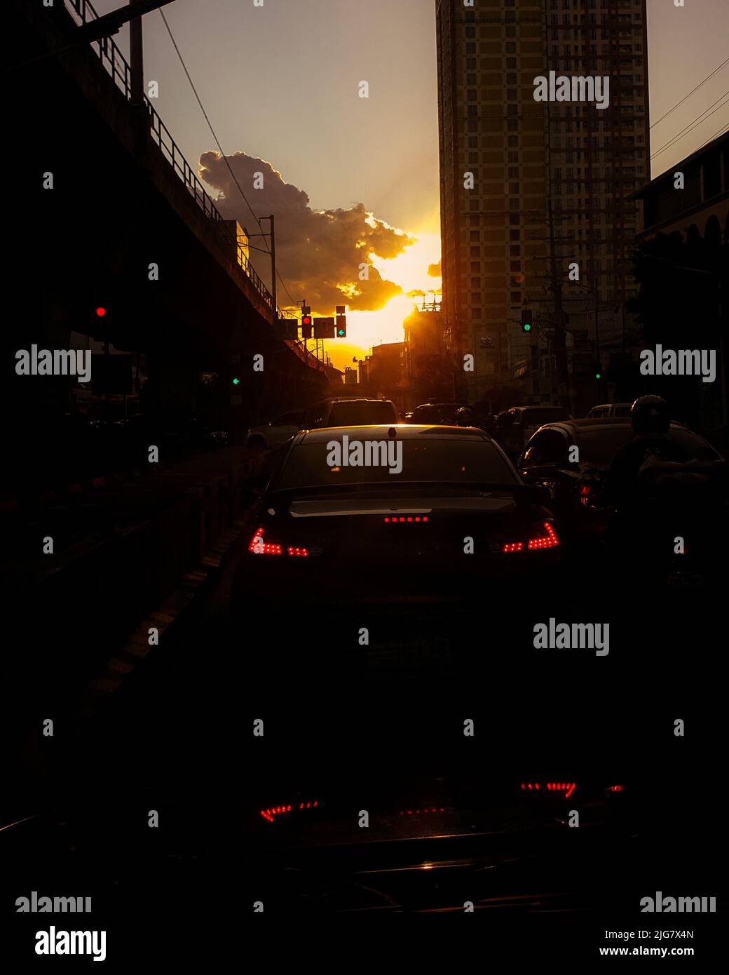 An urban street view with cars and buildings at sunset Stock Photo - Alamy