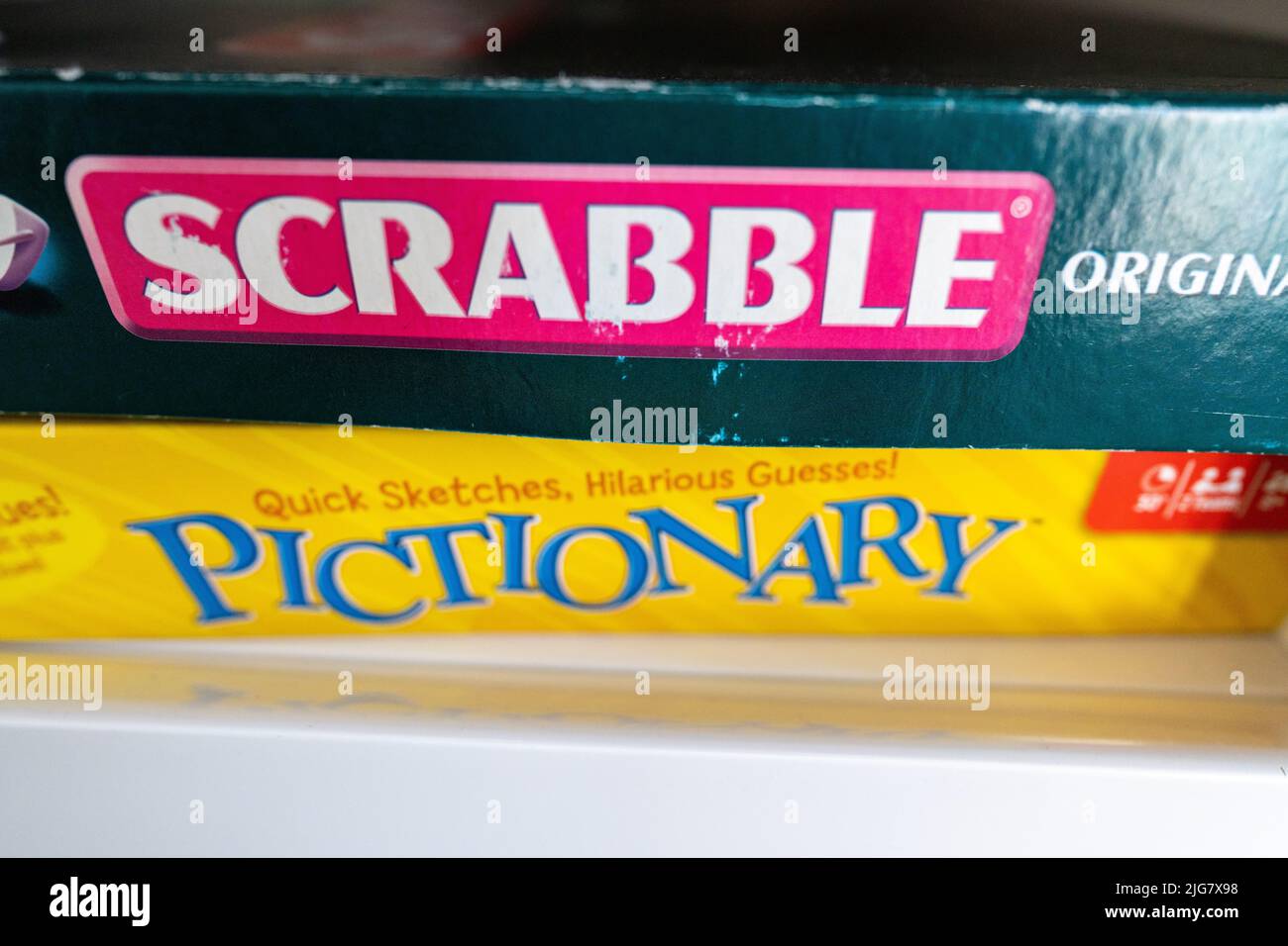 The Scrabble and Pictionary games stacked in a home TV unit Stock Photo ...