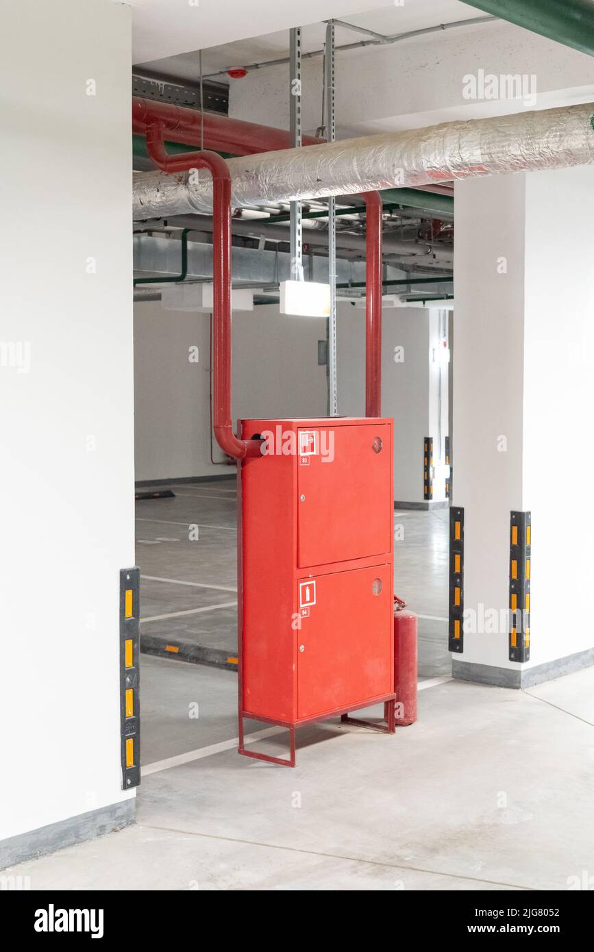 Fire cabinet and fire extinguisher in the underground garage. New house ...