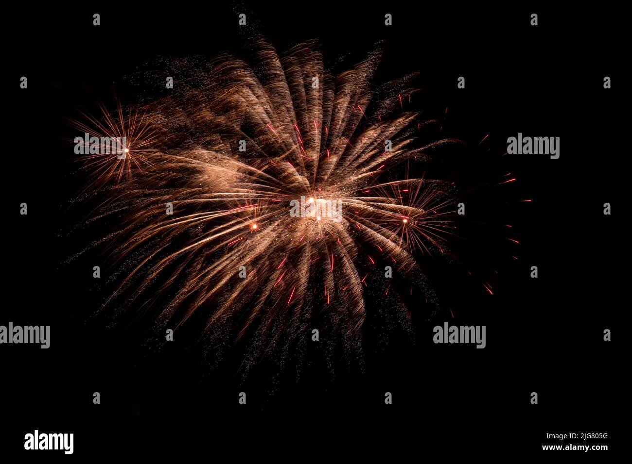 Explosions of pyrotechnics against black night sky. Bright rays of ...