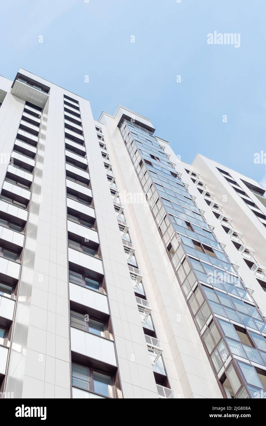 Bottom view of the facade of a multi-storey building with glazed ...