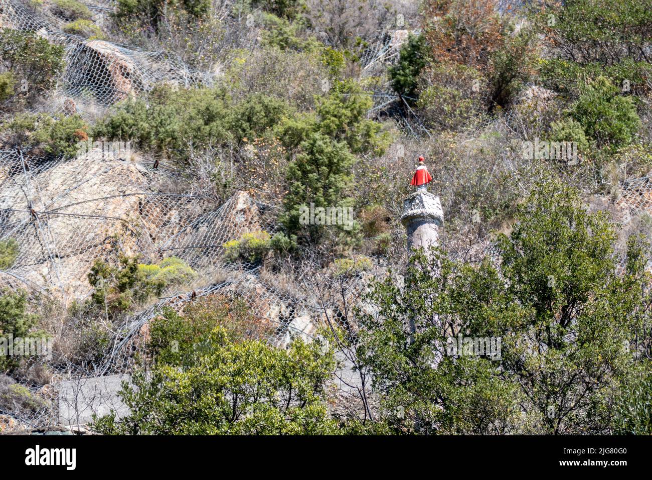 A close-up of a steep cliff wrapped in protective wire mesh Stock Photo ...