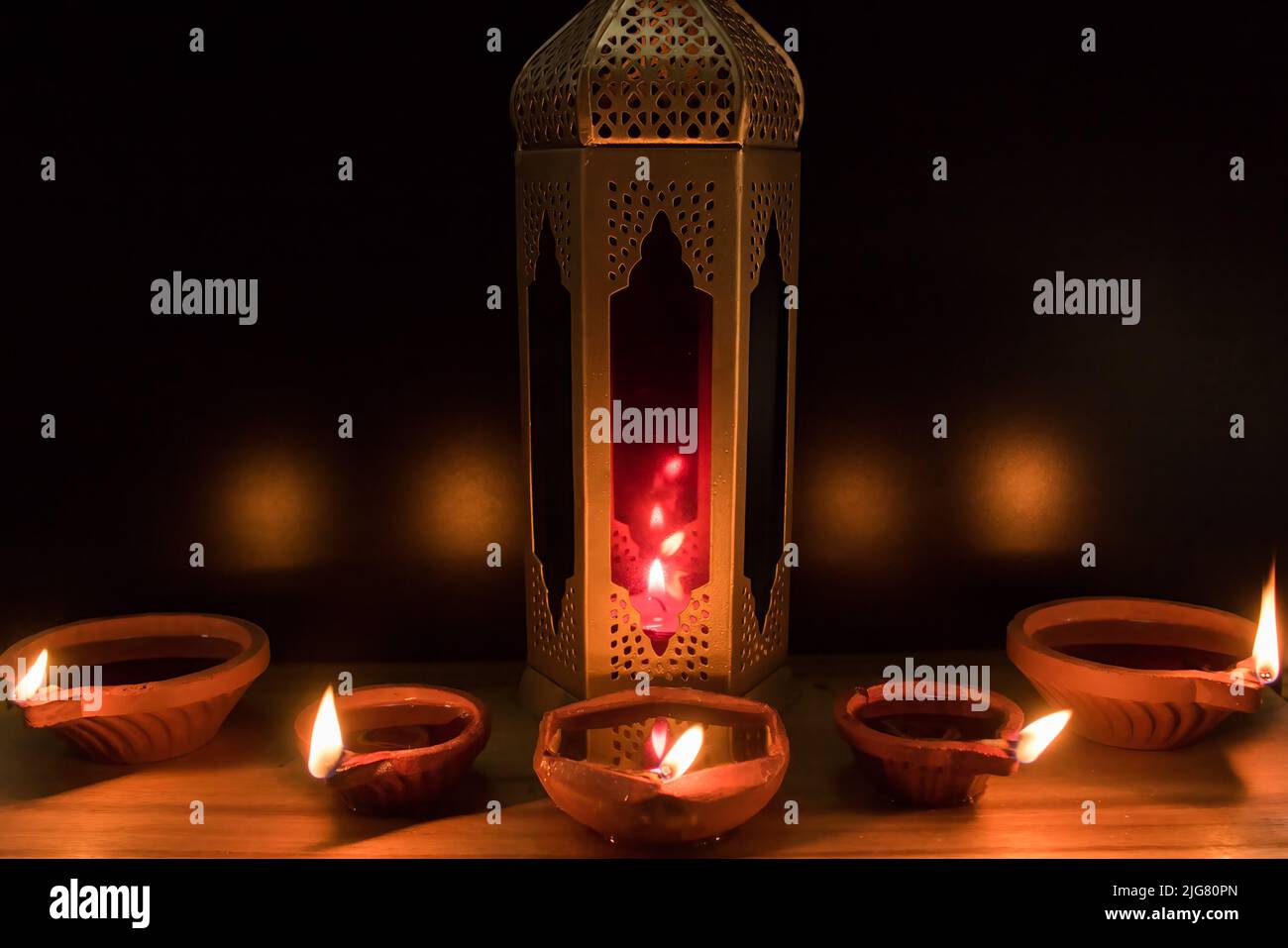 Diya lamp and oil lamp with fire and candles and color on dark ...