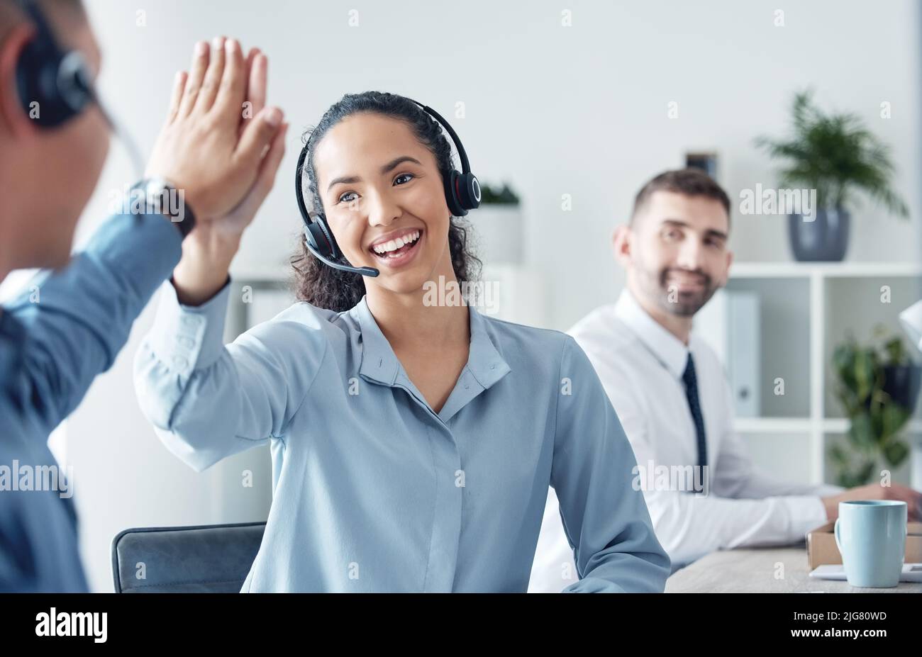 Were winning at this. Shot of two call centre agents giving each other ...