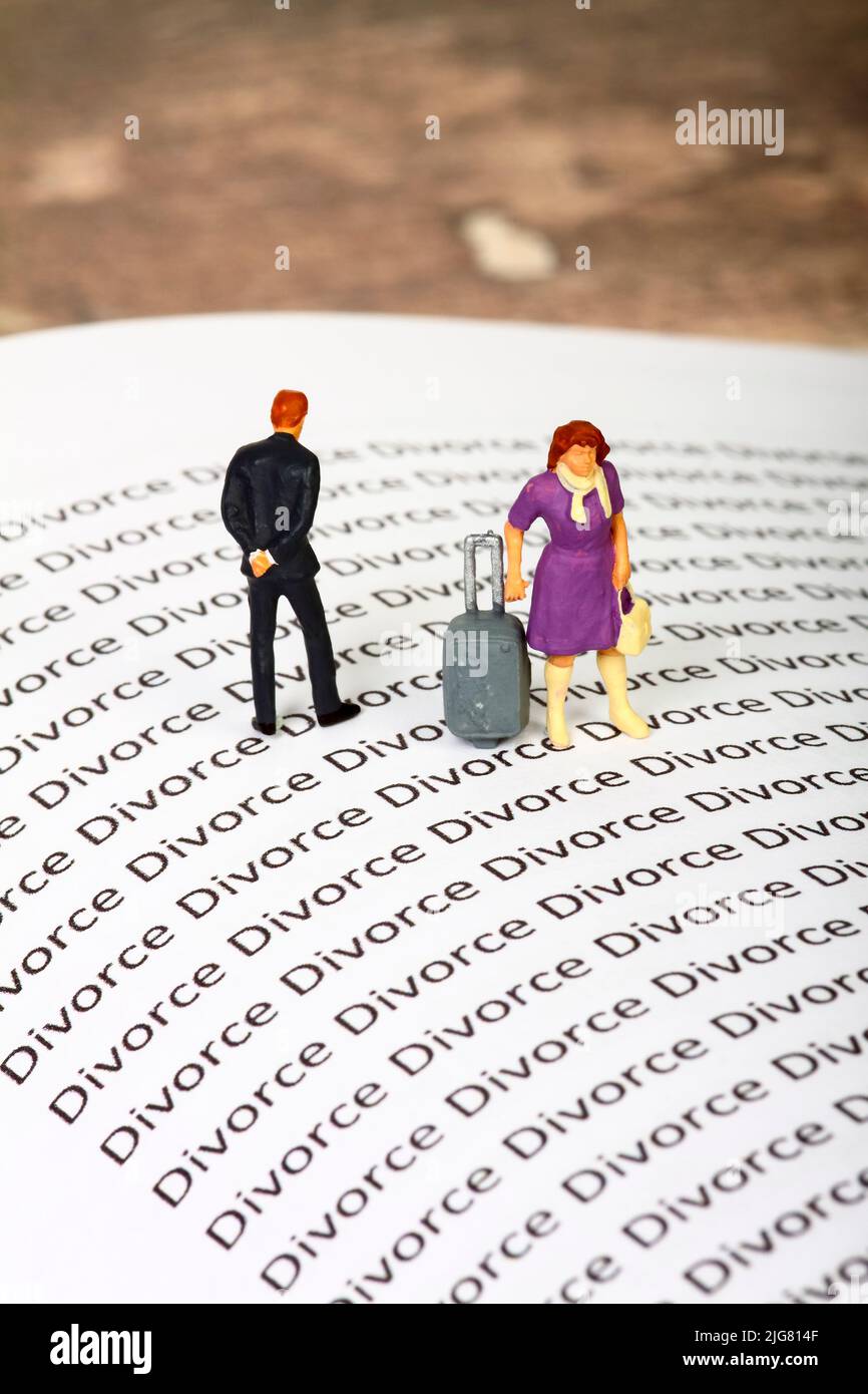 Conceptual image of miniature figure people stood on a book with the ...