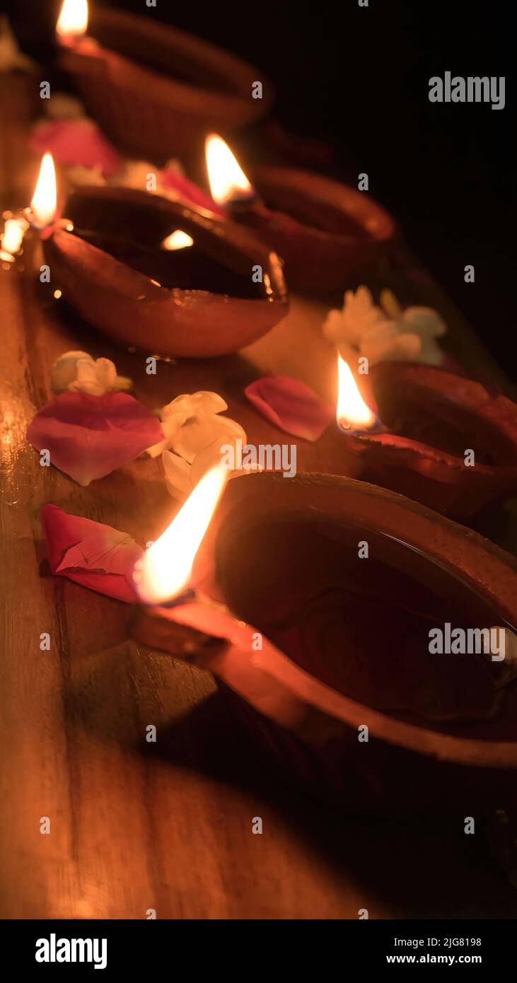 Diya lamp and oil lamp with fire and candles and color on dark ...
