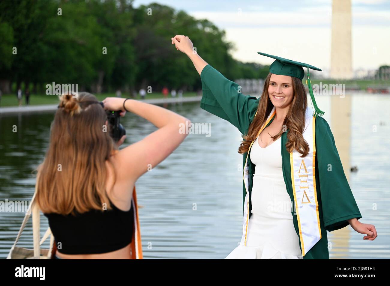 College students celebrate their graduation at the Lincoln Memorial on ...