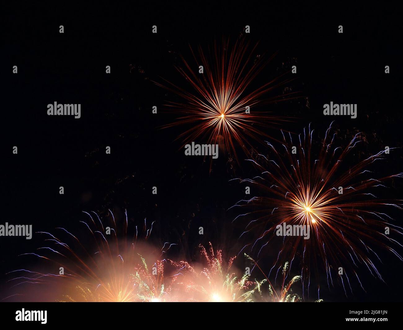 Beautiful fireworks explosion on the dark night sky Stock Photo - Alamy