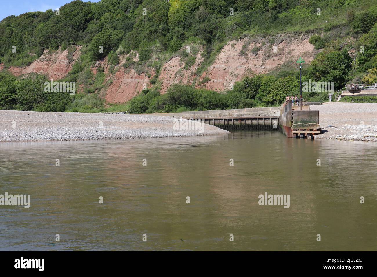 The mouth of the river Axe as it meets the sea at Axmouth in Devon. It ...