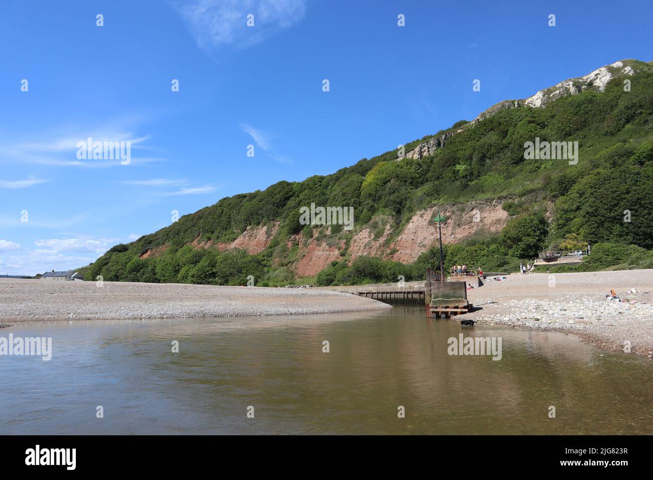 The mouth of the river Axe as it meets the sea at Axmouth in Devon. It ...