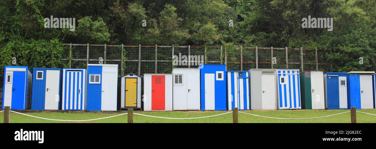 huts of different colors in front of a mountain Stock Photo - Alamy