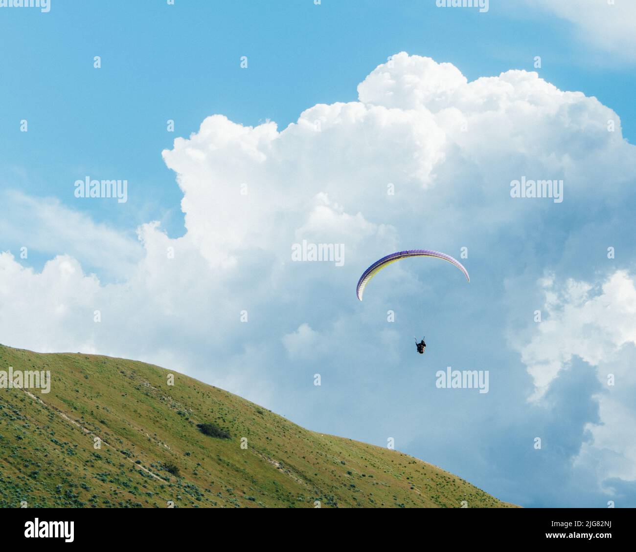 A paraglider flying near the Point of the Mountain in Salt Lake City ...